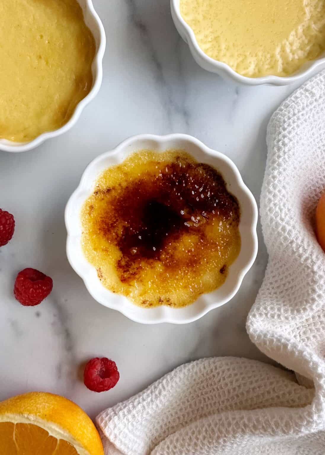 Orange Vanilla Creme Brulee with Raspberry Coulis - Laura Loves to Cook