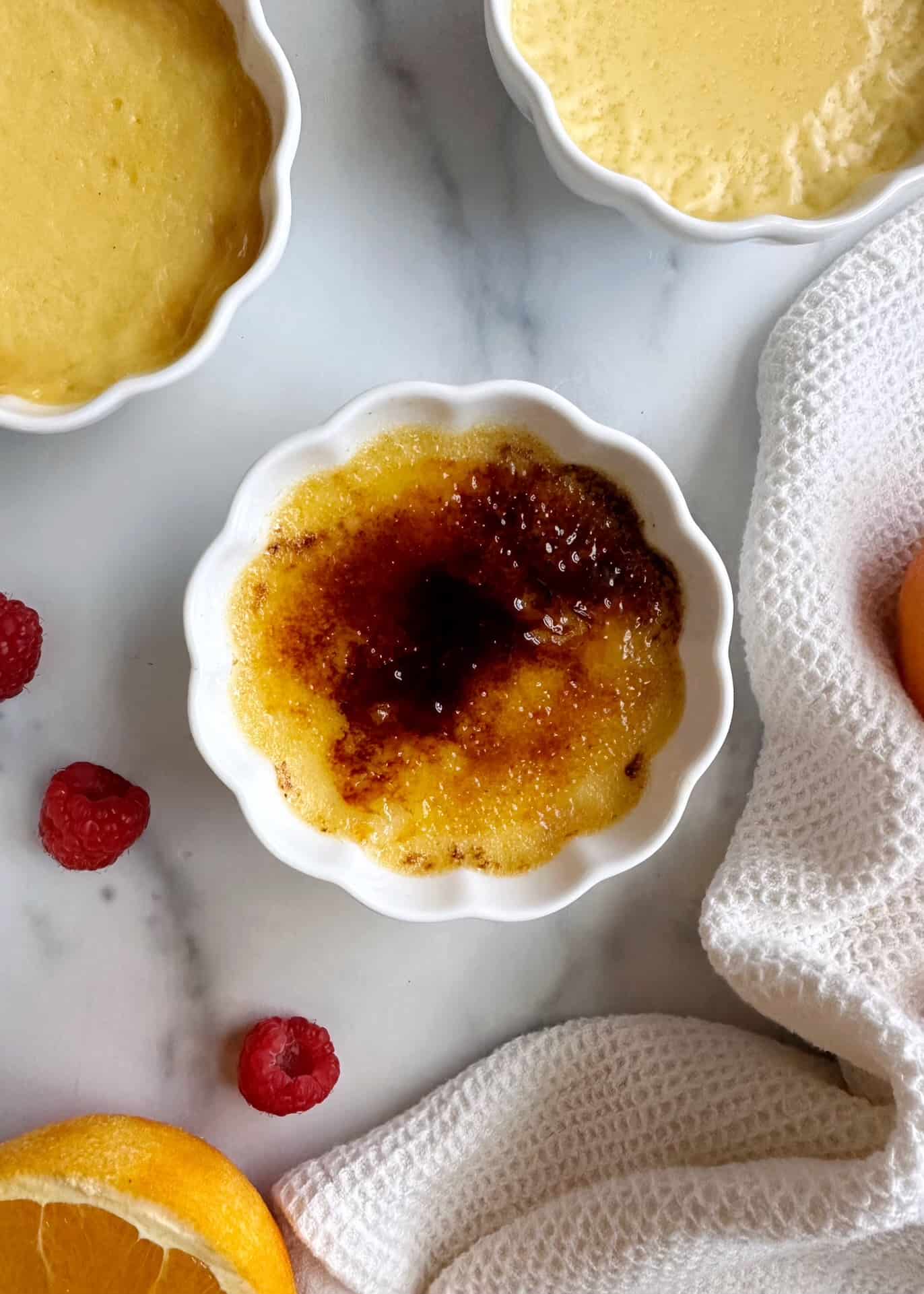 Orange Vanilla Creme Brulee with Raspberry Coulis - Laura Loves to Cook